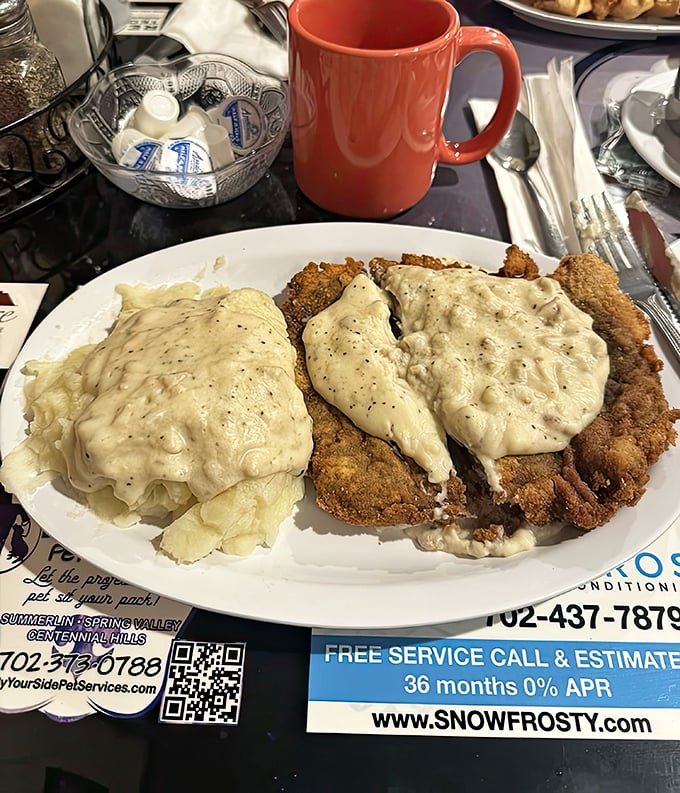 Chicken fried steak swimming in gravy like it's training for the breakfast Olympics – gold medal material right here.