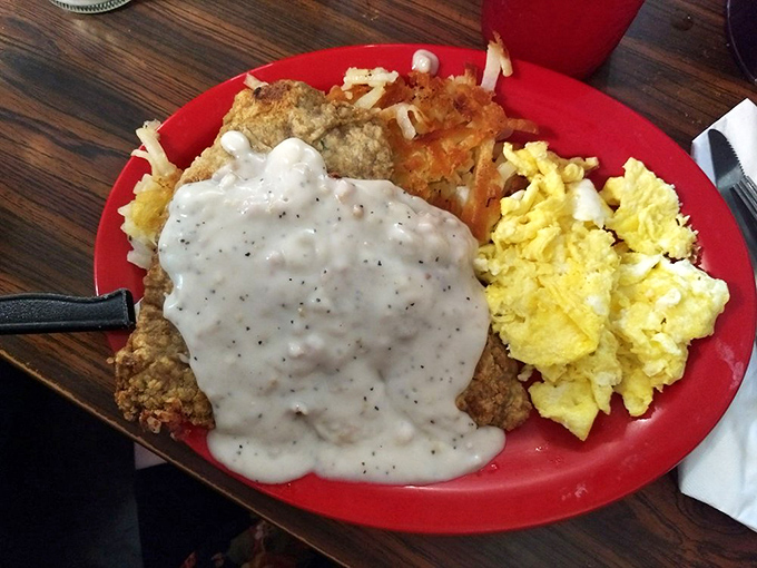 Chicken fried steak that could make a vegetarian weep with temptation. That gravy doesn't just cover—it embraces, completing a breakfast trifecta with eggs and hash browns.