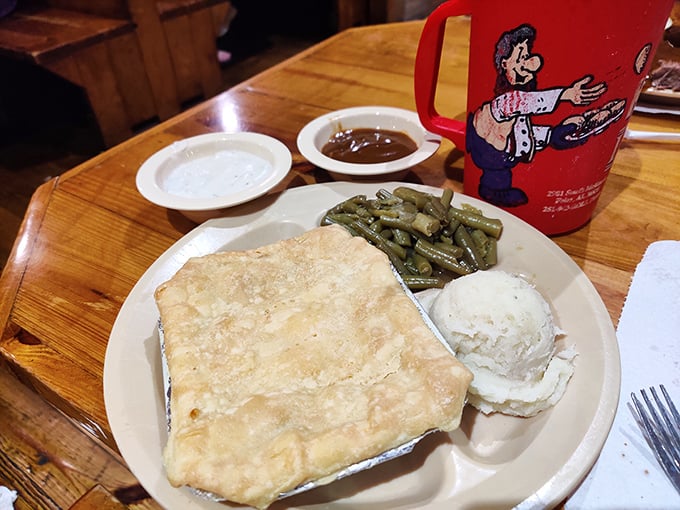 A chicken pot pie heaven with a side of green beans—proof that sometimes the simplest meals deliver the most profound satisfaction.