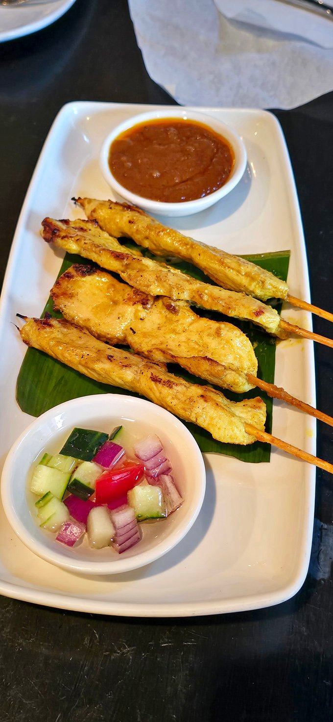 Chicken satay skewers: where grilled perfection meets peanut sauce paradise. The cucumber relish adds that refreshing counterpoint your taste buds didn't know they needed.