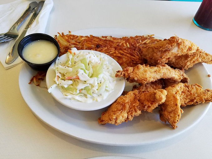 These chicken tenders aren't just crispy—they're life-affirming. Served with creamy coleslaw and crispy hashbrowns that would make your grandmother proud.