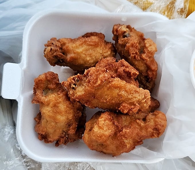 Fried chicken wings with that perfect golden crunch – the kind that announces their arrival with a symphony of crackling sounds.