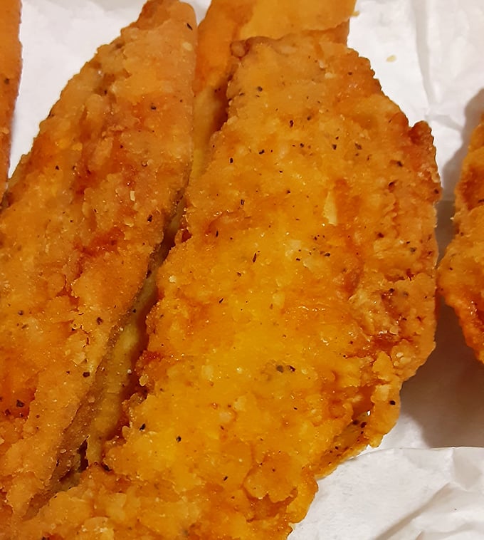 Golden-brown chicken tenders that could make a vegetarian question their life choices. Crispy on the outside, juicy on the inside—the universal language of comfort.