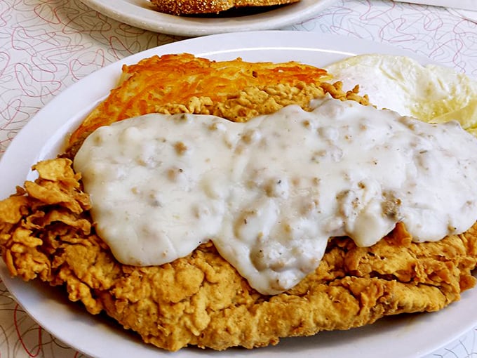 Country-fried steak smothered in gravy—where crispy exterior meets tender interior in a dance as old as diners themselves.