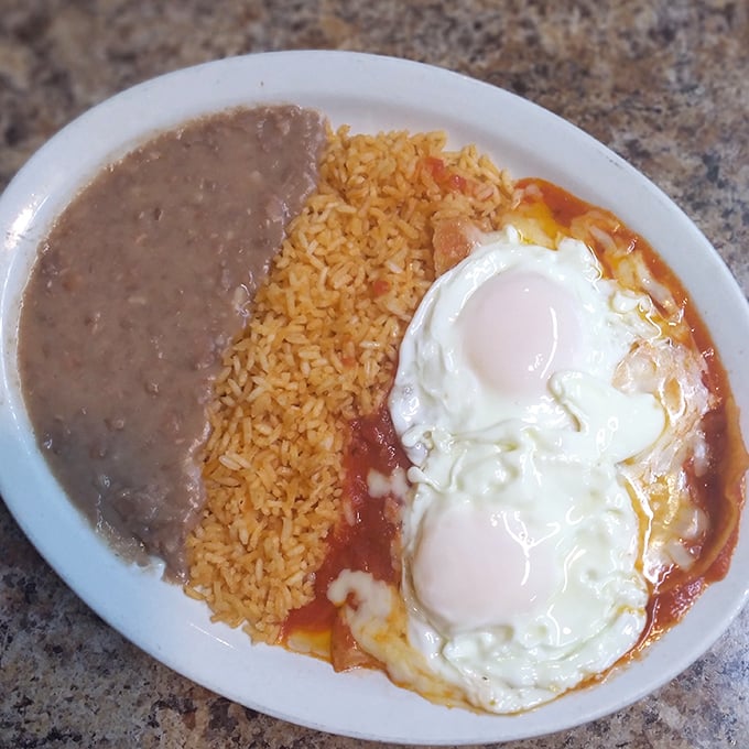 Huevos rancheros elevated to art form – those perfectly cooked eggs nestled in vibrant sauce create the breakfast equivalent of a warm hug.