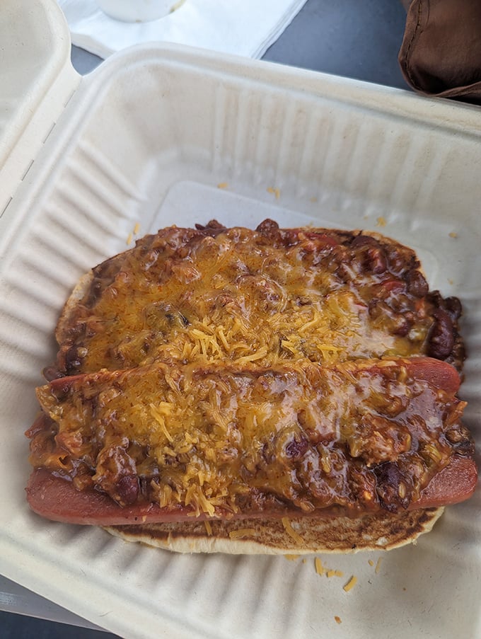 This isn't just any chili dog—it's a masterpiece of melted cheese and savory chili that demands both napkins and your undivided attention.