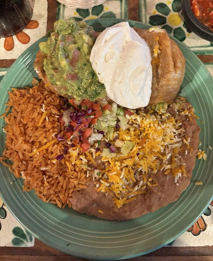 This isn't just a chimichanga – it's a masterclass in texture with that perfect crisp-to-soft ratio and enough guacamole to make a millennial swoon.