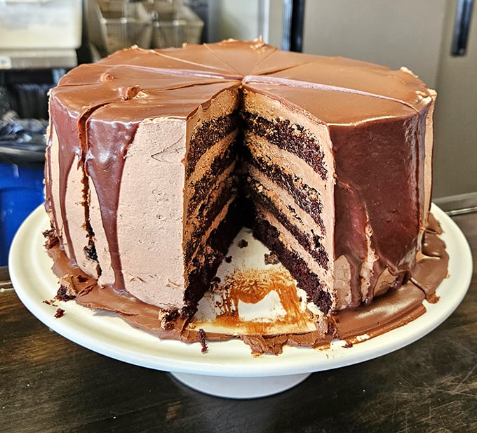This chocolate cake isn't just dessert, it's architecture – layer upon magnificent layer of cocoa perfection that would make Willy Wonka weep with joy.