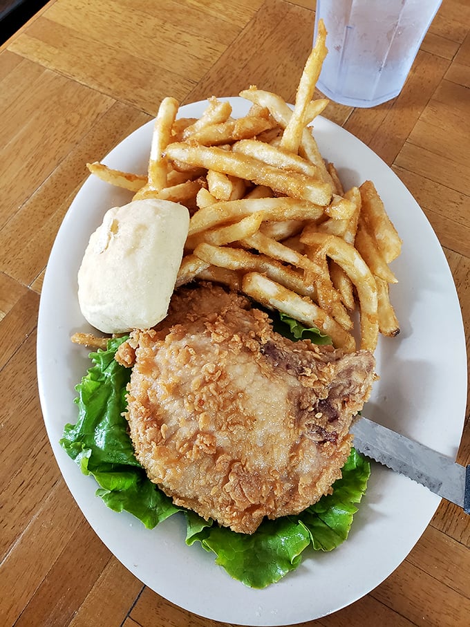Crispy fries piled high next to a golden-fried masterpiece – proof that sometimes the simplest meals deliver the most profound satisfaction.