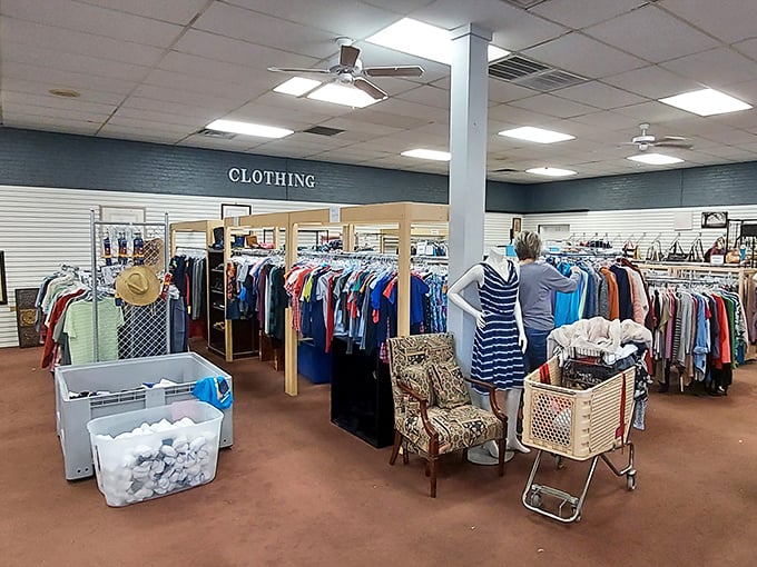 The clothing section: where "retail therapy" meets "budget-friendly." Shoppers browse racks organized by size, not chaos—a thrift store miracle.