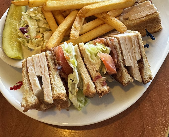 The club sandwich—architectural marvel of turkey, bacon, lettuce and tomato—arrives with a side of nostalgia and enough french fries to share (but you won't want to).