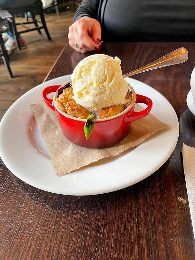 This warm cobbler topped with vanilla ice cream doesn't just end a meal—it creates a memory. The little red crock says "homemade" before your first bite.