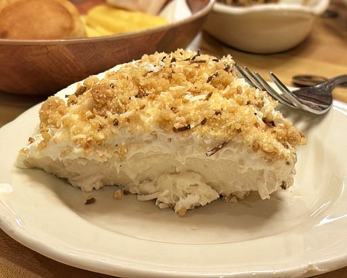 Coconut cream pie that would make your grandmother both jealous and proud—a cloud-like mountain of sweet nostalgia topped with toasty crumbs.