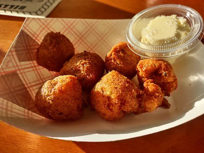 Conch fritters – golden-brown spheres of Caribbean flavor that crunch then melt, making you momentarily forget about your diet plans.
