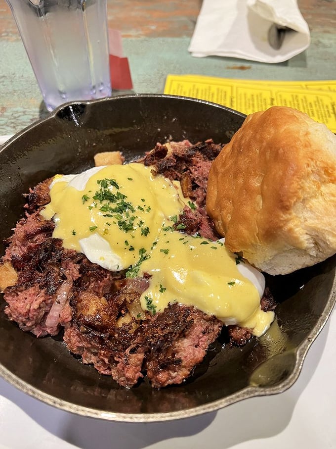 Corned beef hash topped with poached eggs and hollandaise in cast iron—deli meets diner in the most delicious way.