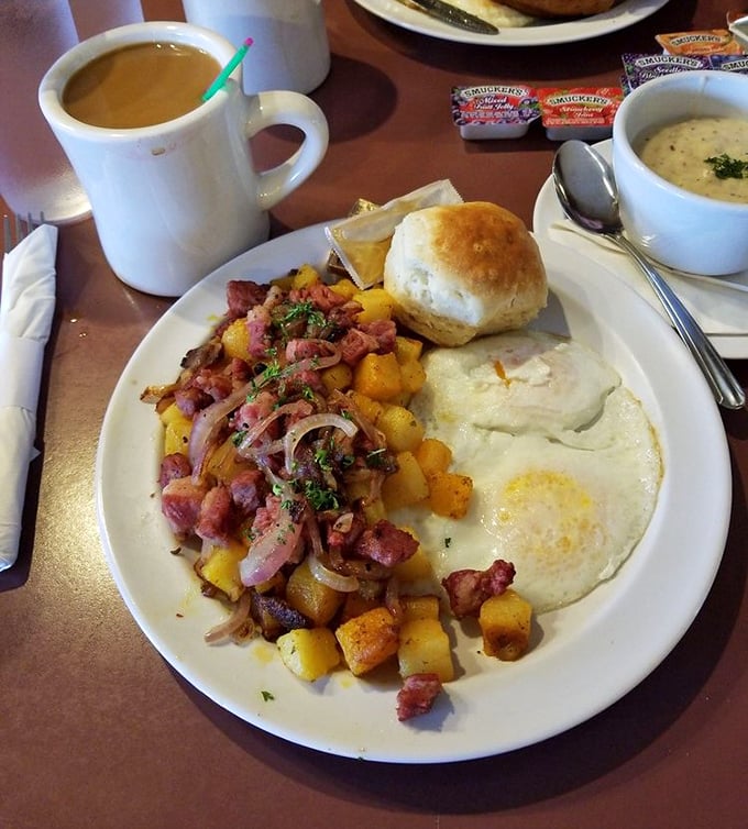 A hearty breakfast plate featuring seasoned potatoes mingling with ham and eggs—the kind of fuel that powers Pacific Northwesterners through rainy mornings.