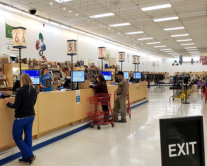 Checkout heaven with numbered lanes—the finish line of the thrifting marathon where victory is measured in both savings and finds.