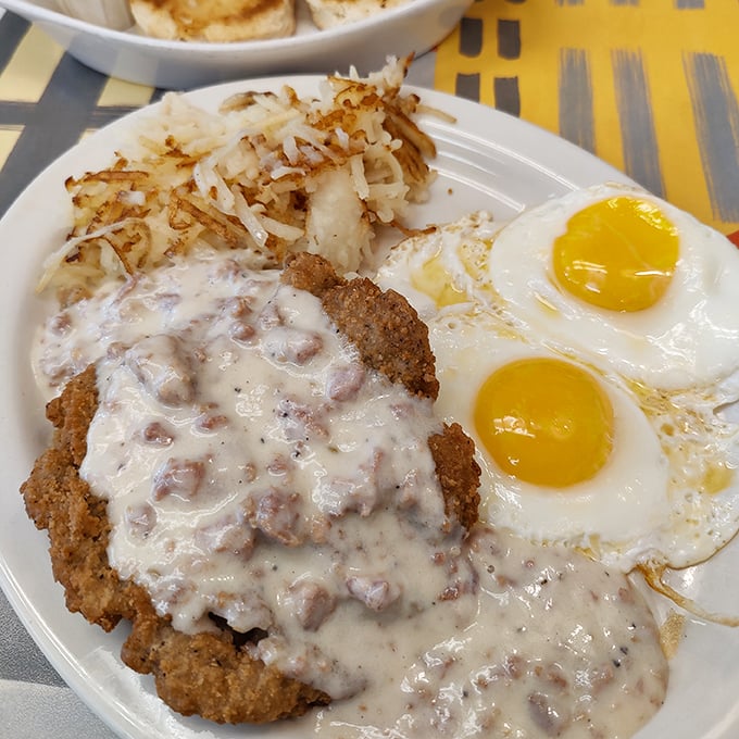 Country fried steak that's had a proper upbringing—crispy exterior, tender inside, and smothered in gravy that would make your grandmother nod in approval.