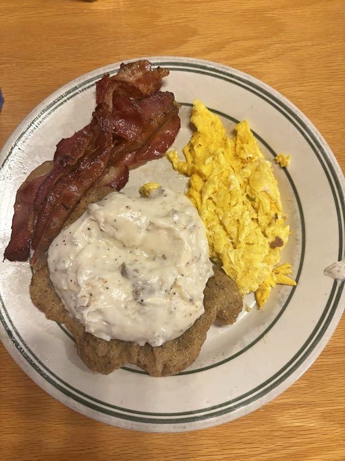 Country fried steak with gravy – because sometimes breakfast should be hearty enough to fuel a space shuttle launch.