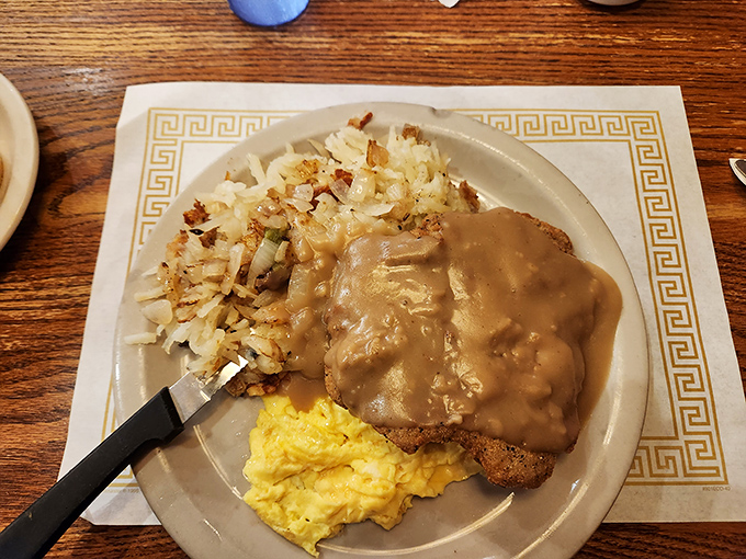 Country fried steak smothered in gravy—because some mornings require more than just coffee to face the day ahead.