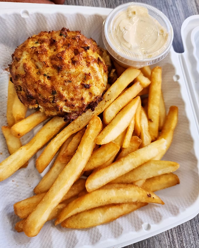 The platonic ideal of a Maryland crab cake—golden-brown exterior, minimal filler, and served with fries that are clearly not an afterthought.
