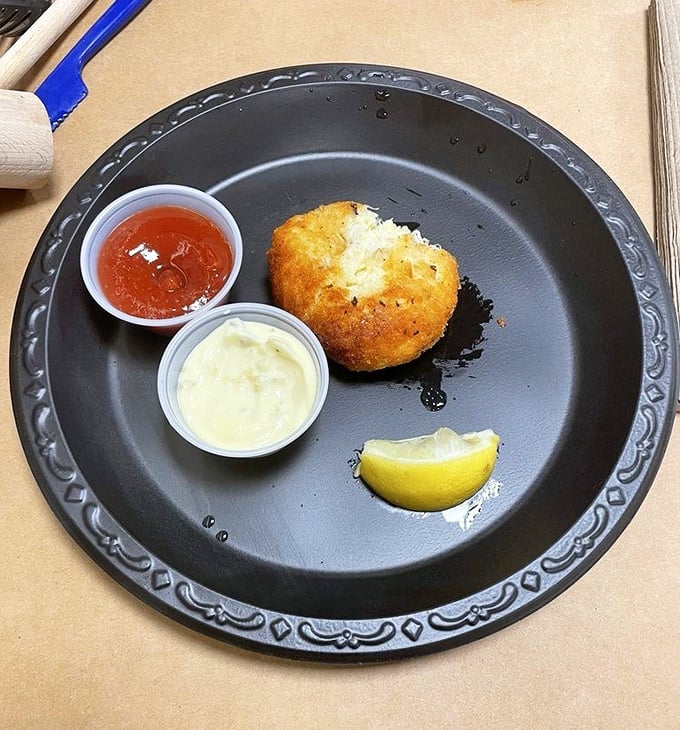 The Maryland crab cake in its natural habitat—minimal filler, maximum flavor. That golden crust gives way to sweet lump meat that tastes like the Chesapeake itself.