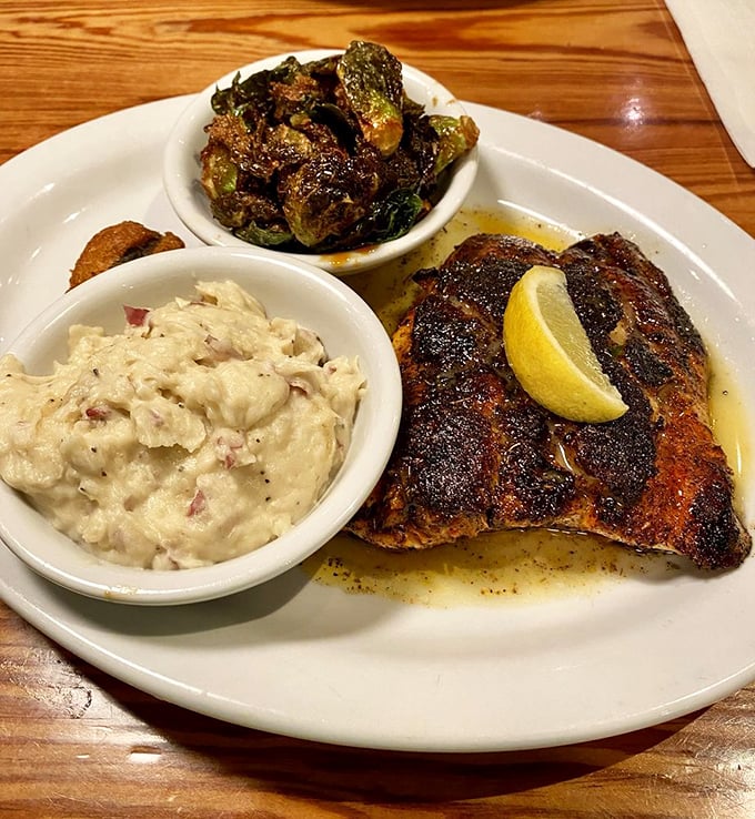 Blackened fish meets creamy grits and roasted Brussels sprouts – a plate that proves Southern cooking isn't just comfort food, it's sophisticated comfort food.