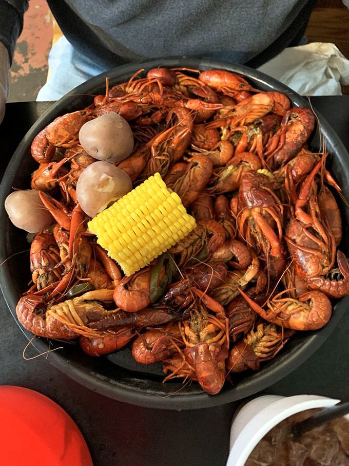 Crawfish served with corn and potatoes isn't just a meal – it's a social event where the spice-to-sweat ratio is perfectly calibrated.