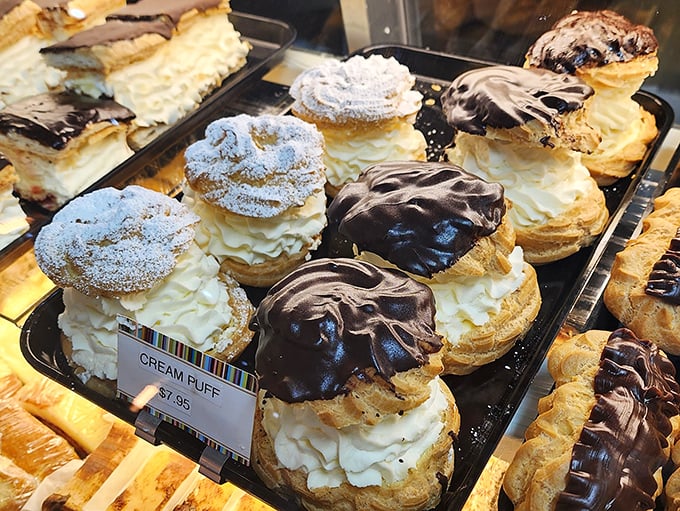 Cream puffs wearing chocolate hats and powdered sugar bow ties – part dessert, part fashion statement, all delicious. Coco Chanel would approve.