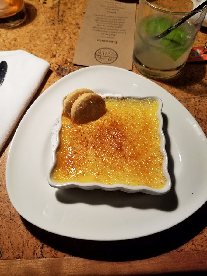 Crème brûlée with that perfect glass-like sugar crust – tap it with your spoon and listen for that satisfying crack that signals dessert nirvana.