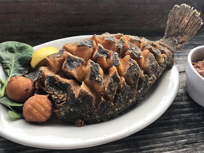 The whole flounder arrives scored and fried to crispy perfection – a dish that makes you wonder why you ever settled for fillets.