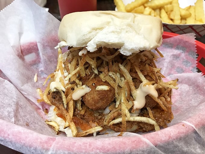 The legendary Cuban frita in all its glory—a seasoned patty crowned with crispy potato shoestrings that would make royalty jealous.