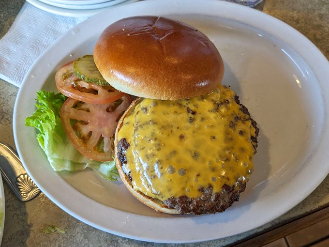 A cheeseburger that doesn't need gimmicks—just perfectly melted cheese, fresh toppings, and a bun that knows its supporting role in this meaty masterpiece.