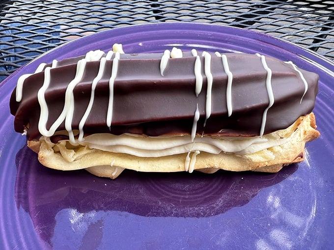Chocolate eclair perfection on a purple plate – proof that sometimes the most beautiful things in life are the simplest.
