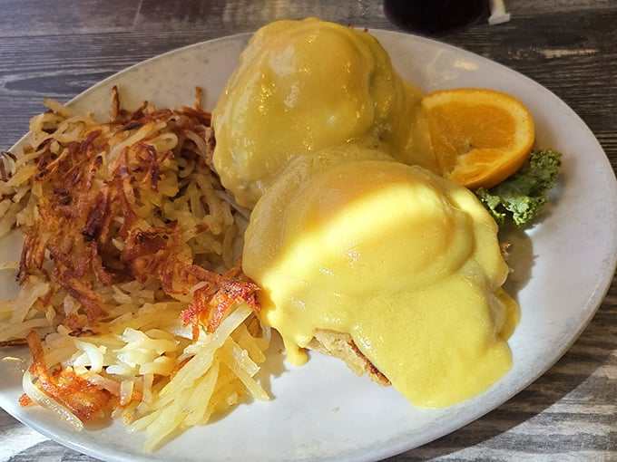 Eggs Benedict done right—golden hollandaise cascading down like a sunrise over the Ozarks. Those hash browns deserve their own fan club.