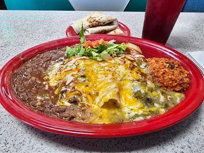 Christmas came early – red and green chile blanketing these enchiladas like a spicy security blanket for your taste buds. New Mexico's gift to humanity.