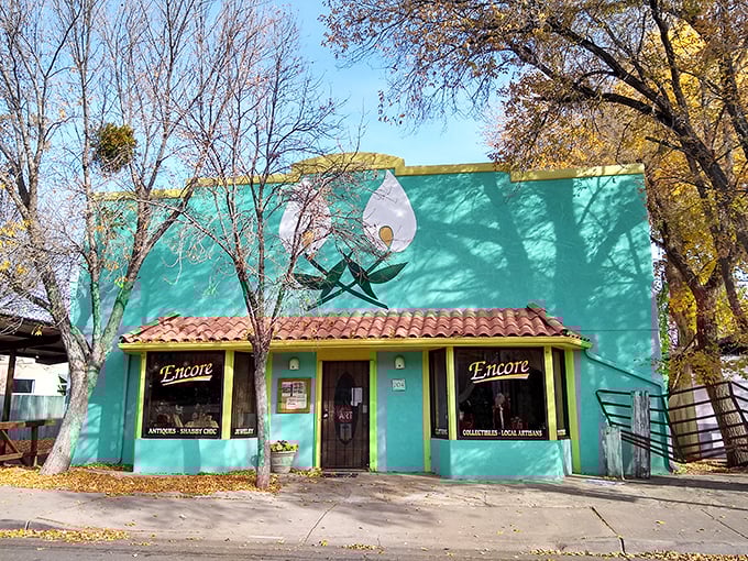 Encore's turquoise walls pop against autumn leaves, proving antique shops don't have to look like dusty attics.