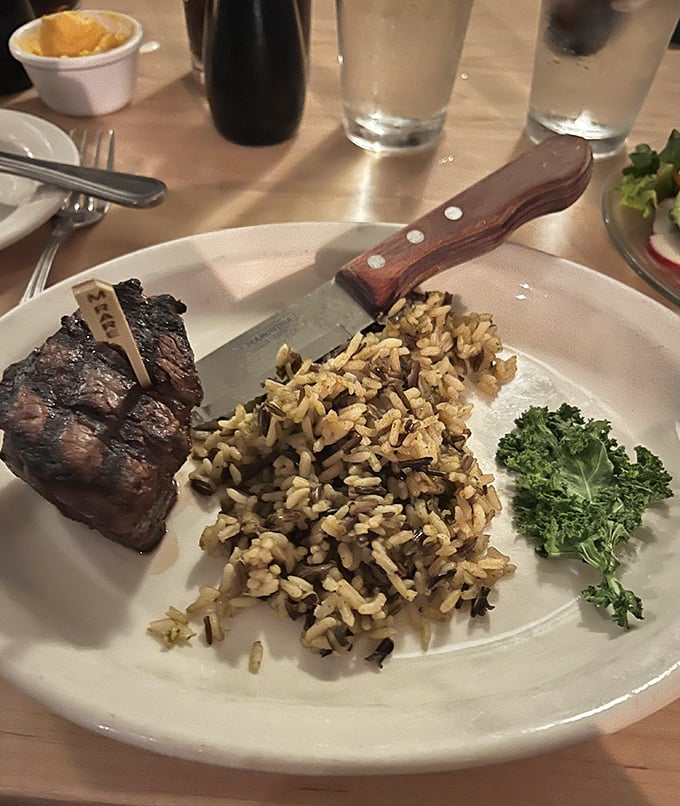 A beautifully charred filet mignon served alongside wild rice shows that variety thrives alongside that legendary prime rib here.