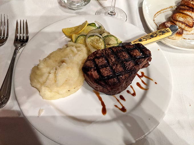 The filet mignon arrives like royalty—tender enough to cut with a whisper, accompanied by mashed potatoes so creamy they deserve their own fan club.