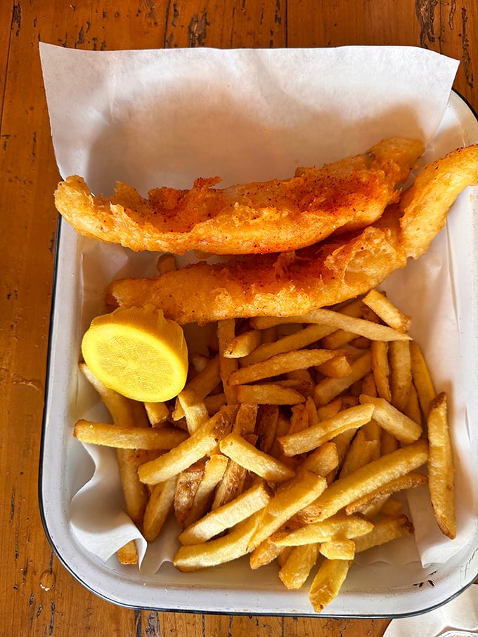 Fish and chips that actually crunch when you bite them—a rarity that deserves its own parade. The lemon wedge isn't just garnish; it's essential equipment.