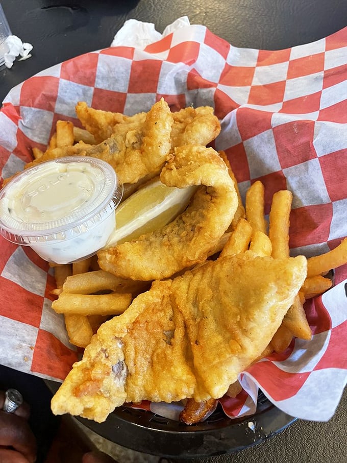 Fish and chips that would make a British pub jealous. Golden, crispy perfection surrounding flaky white fish—the kind that makes conversation stop mid-sentence.