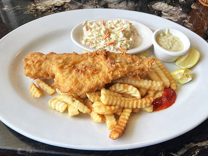 Golden-battered fish and crispy fries—a seaside classic executed with diner precision. That coleslaw isn't just a side; it's a necessity.