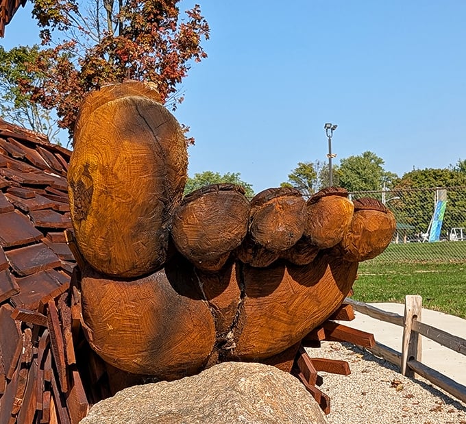 Those aren't just big feet—they're masterpieces of woodcarving. Each toe is carefully sculpted from solid logs, anchoring this gentle giant to his Ohio home.