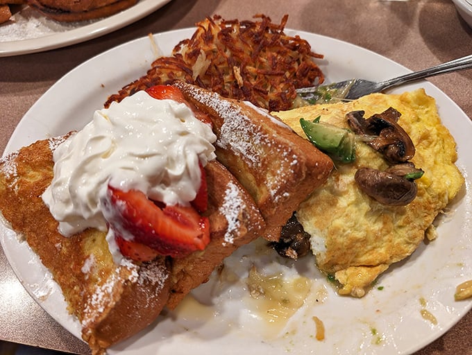 French toast topped with fresh strawberries and whipped cream – because sometimes breakfast should feel like dessert.