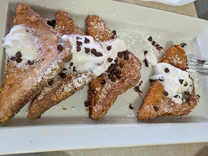 French toast that doesn't just whisper "good morning"—it belts out a Broadway musical. The whipped cream and chocolate chips are the standing ovation.