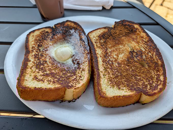 French toast that's achieved that magical alchemy—crispy exterior, custardy interior. The butter melting in the center is nature's way of saying "good morning."