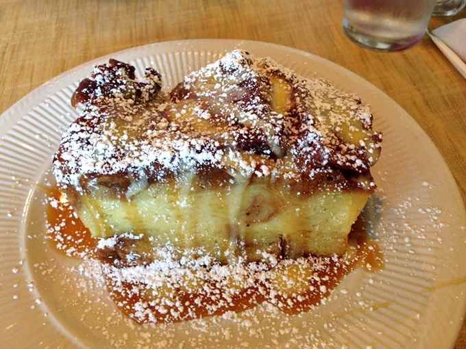 This isn't just French toast – it's what French toast dreams of becoming when it grows up. The powdered sugar snowfall is just showing off.