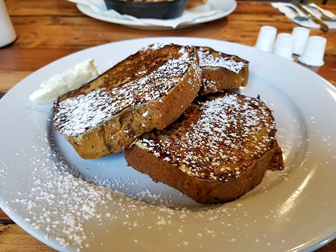 French toast that's dressed for success—powdered sugar snow on thick-cut challah that's been bathing in cinnamon-kissed batter. Breakfast royalty, indeed.