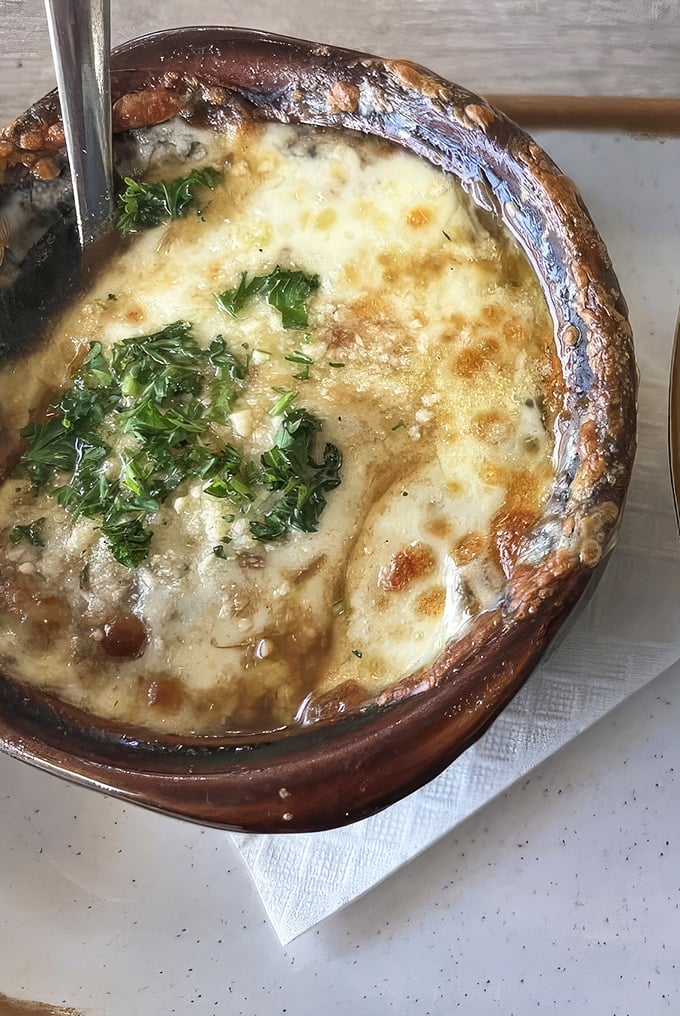 French onion soup that's achieved the perfect cheese-pull-to-broth ratio, with herbs adding a fresh pop to this bubbling cauldron of comfort.