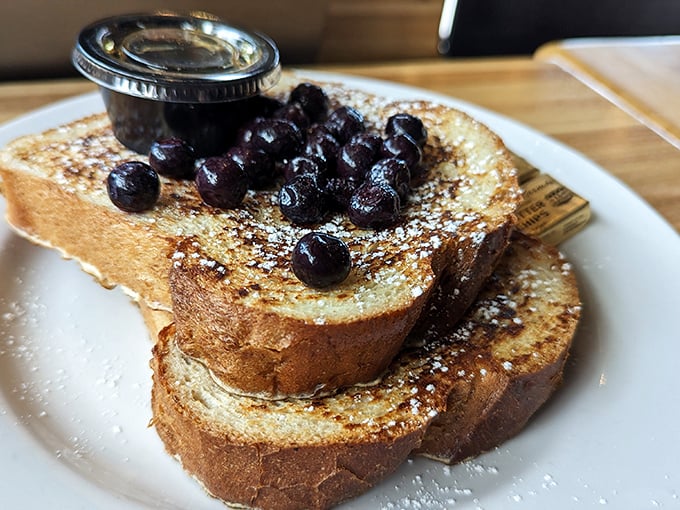 French toast that makes you question every other breakfast you've ever had. Those blueberries aren't just toppings – they're little purple jewels.